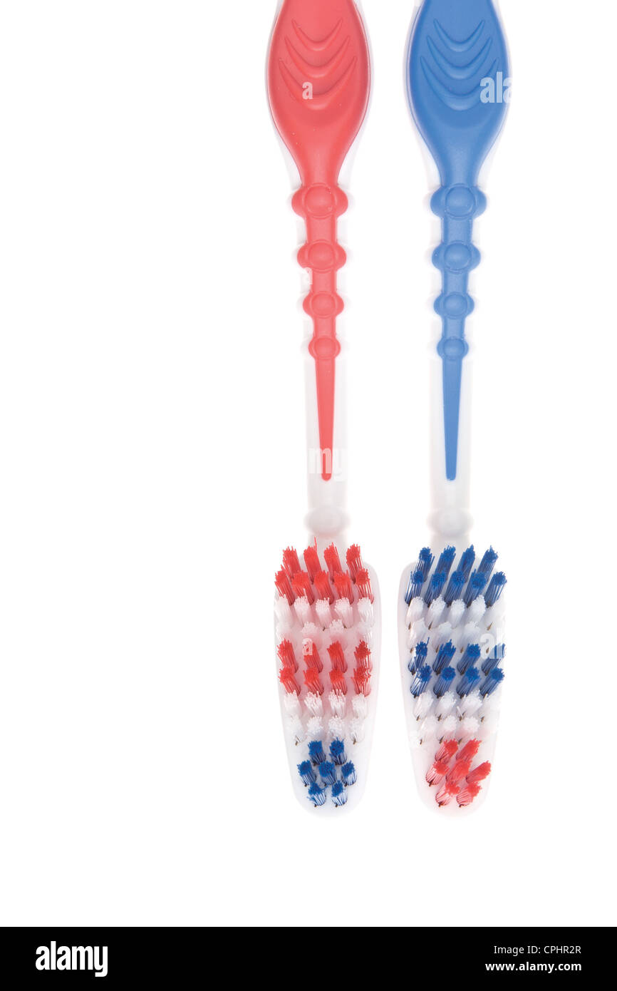Two toothbrushes. Red and blue, with white background Stock Photo - Alamy