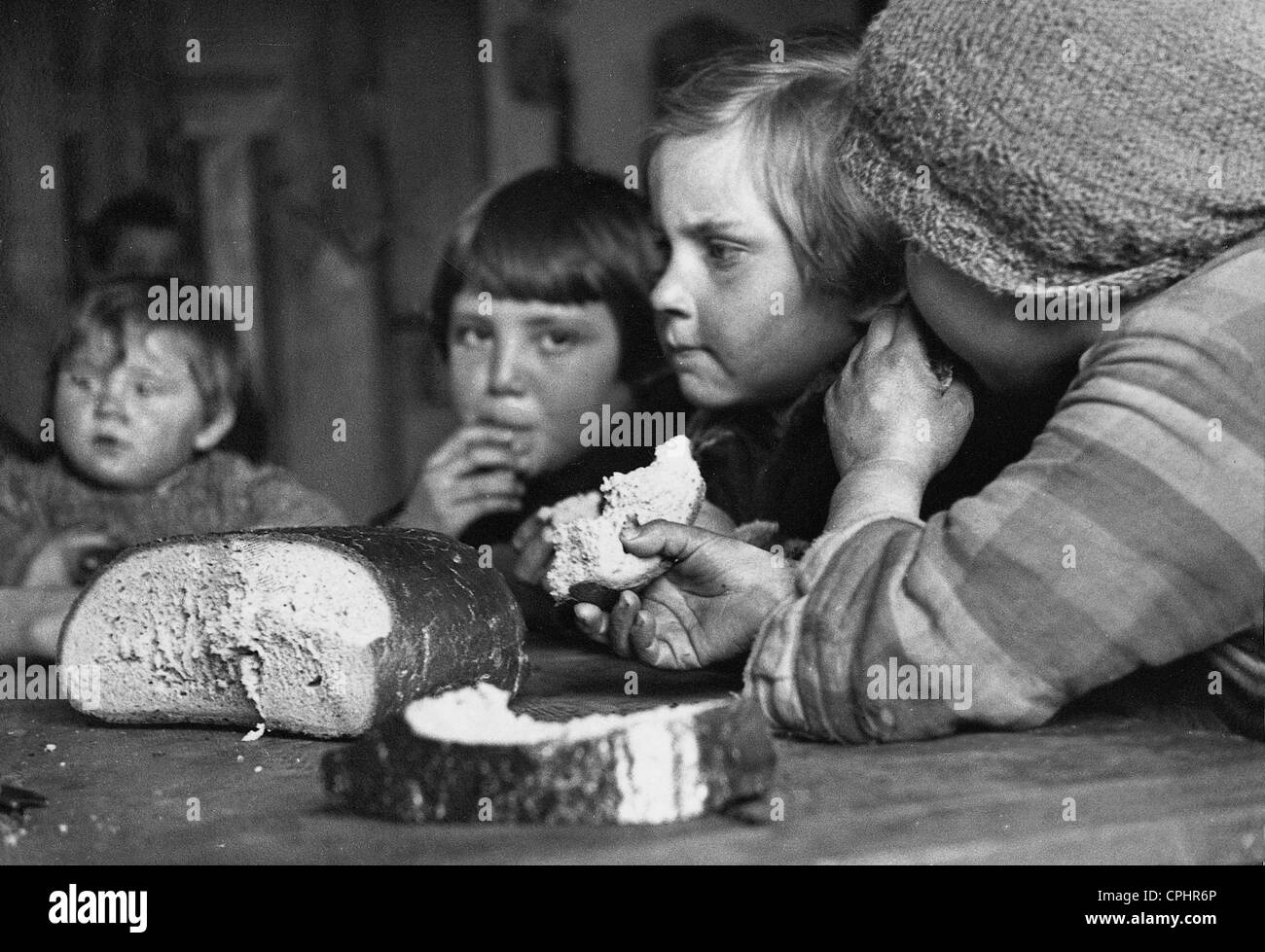 Children eat bread, 1934 Stock Photo - Alamy
