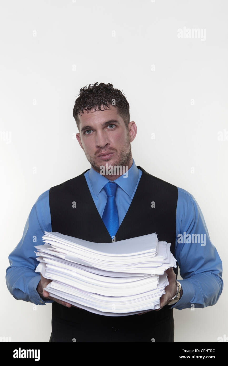 man holding a large pile of paper work in his arms Stock Photo - Alamy