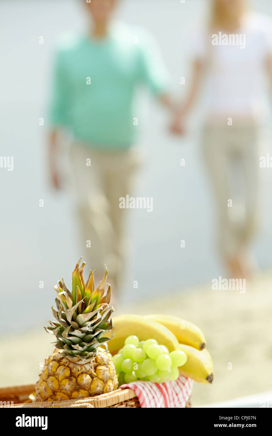 Photo of fruits with walking couple on background Stock Photo - Alamy