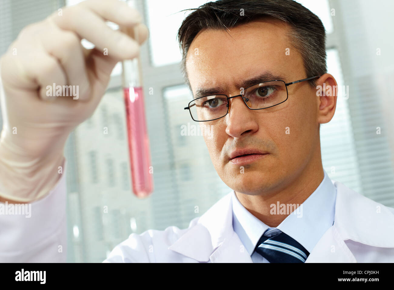 Male scientist in eyeglasses studying a substance Stock Photo - Alamy