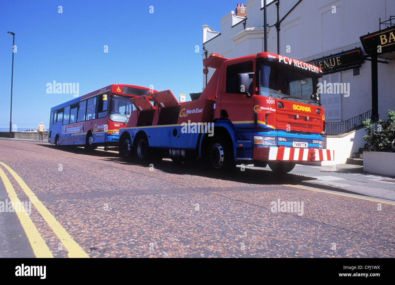 A PCV recovery truck attending a broken down public service bus at a ...