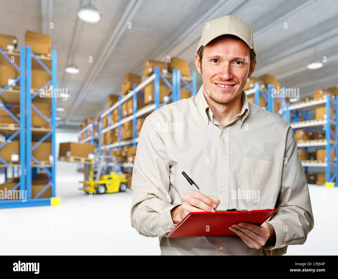 smiling worker in warehouse work place Stock Photo - Alamy