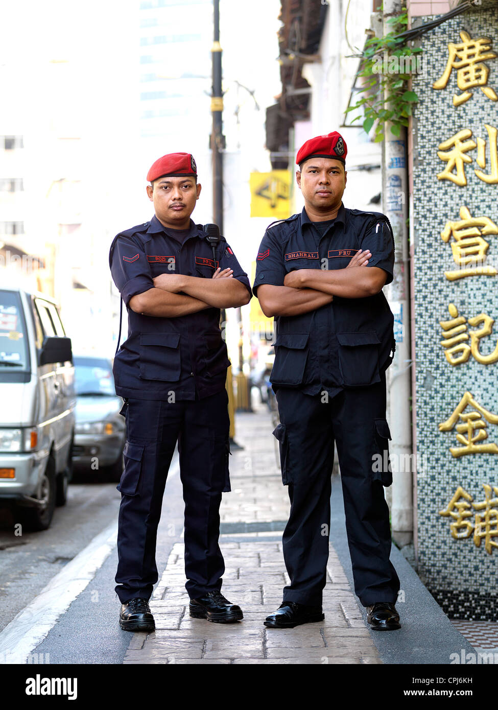 Two security guards striking a pose with their arms crossed Stock Photo ...