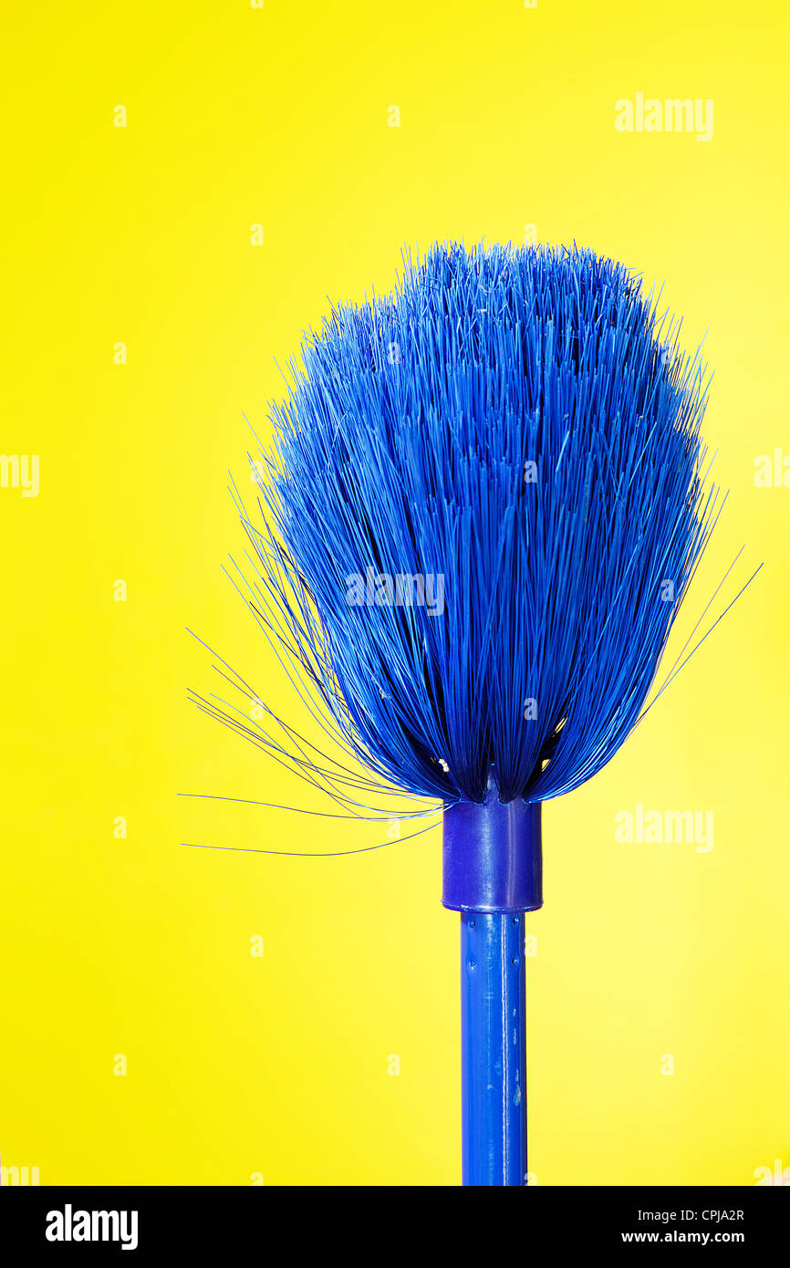 Blue broom on Yellow Stock Photo - Alamy