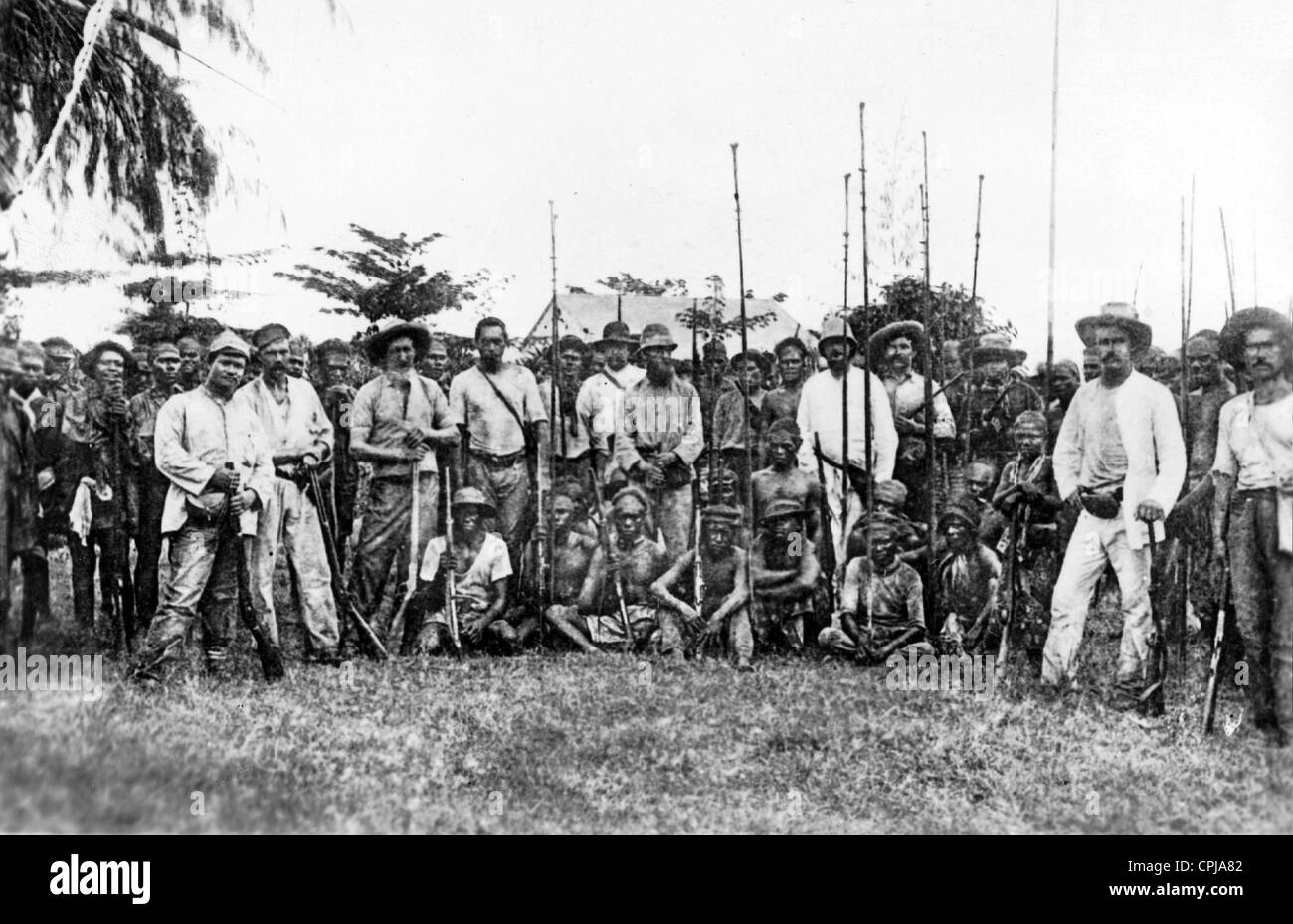 Supervisors and indigenous workers Stock Photo - Alamy