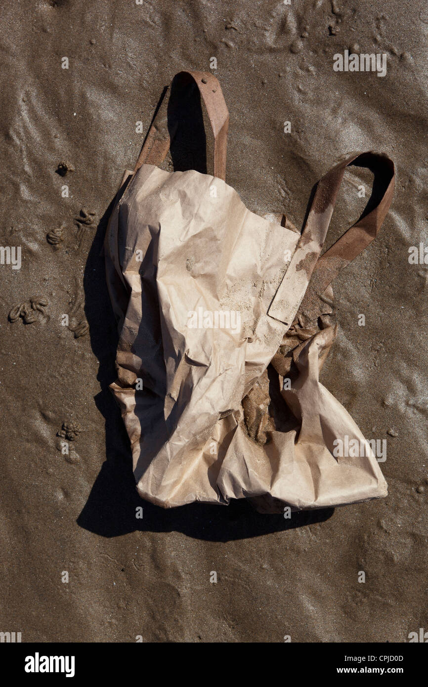 Empty Brown Paper Bad left in Sand on Beach Stock Photo - Alamy