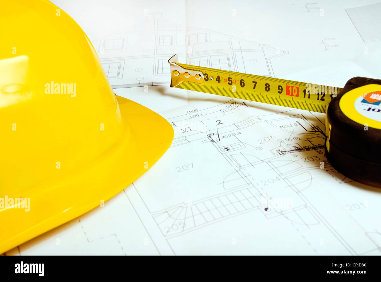 construction plan, measuring tape and hard hat Stock Photo - Alamy