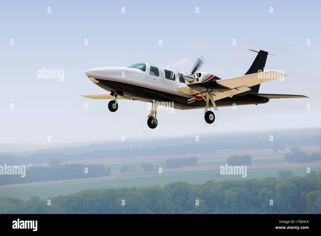 Airplane landing or taking off with gear down Stock Photo - Alamy