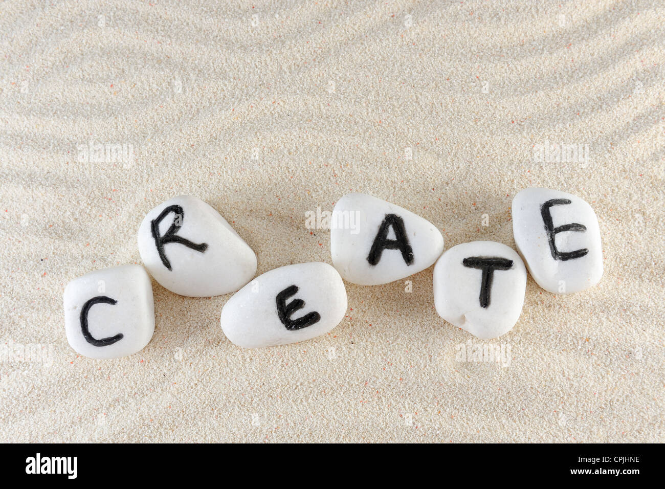Create word on group of stones with sand as background Stock Photo - Alamy