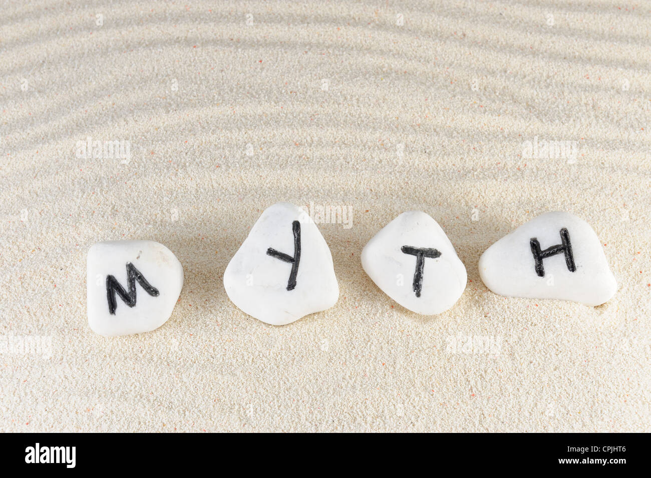 Myth word on group of stones with sand as background Stock Photo - Alamy