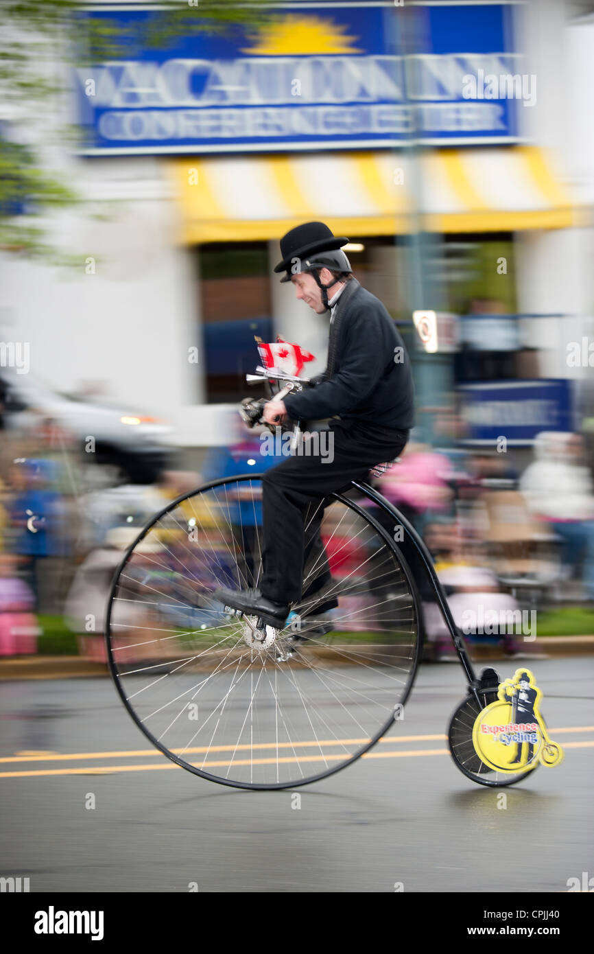 Man riding Penny Farthing bicycle during 2012 Victoria Day Parade ...