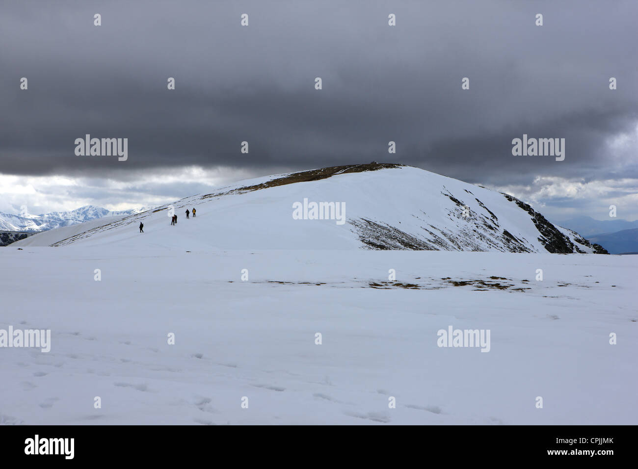 A group of walkers descending from the summit of Creag Meagaidh (1130m ...