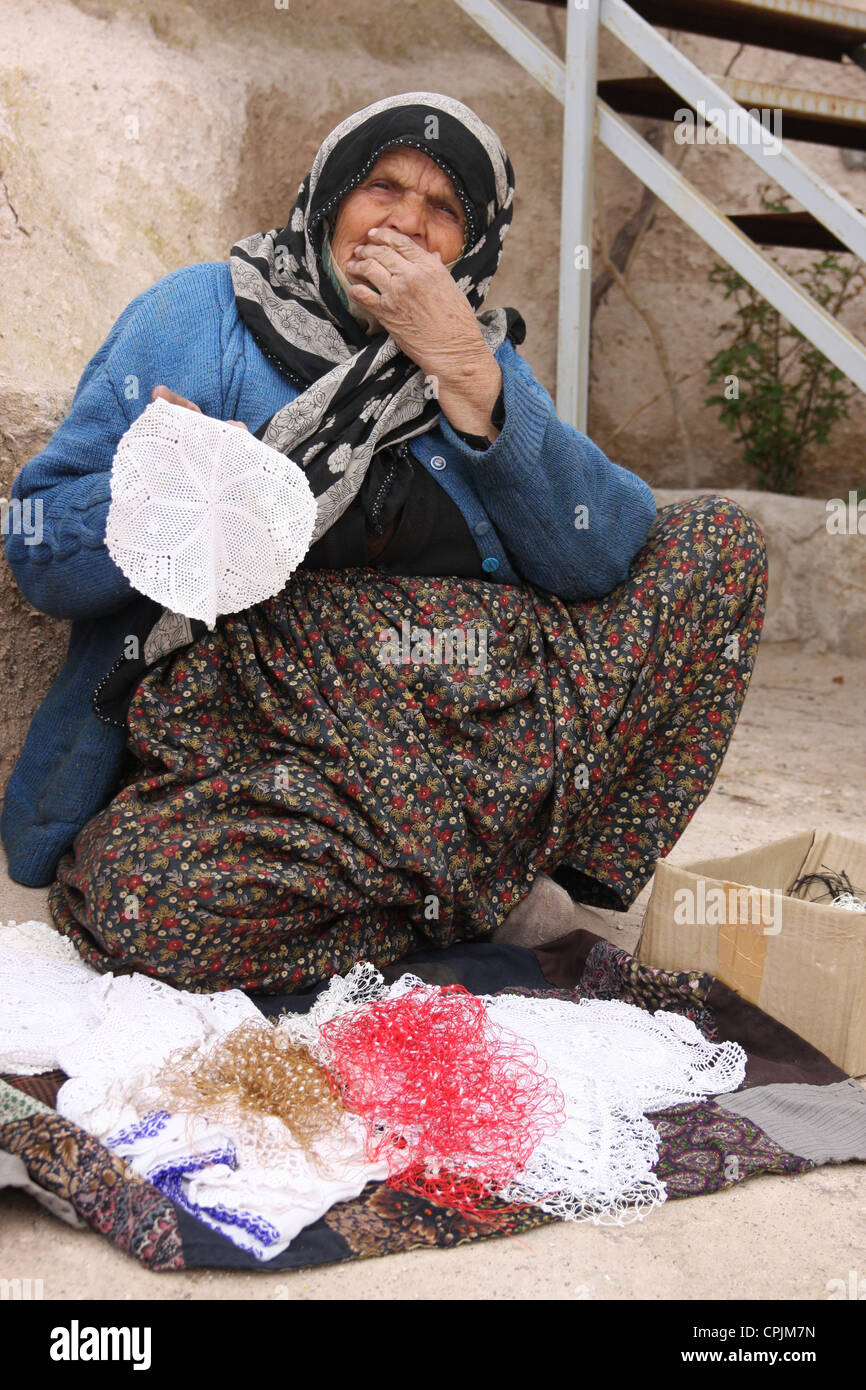 Traditional Muslim lady in Cappadocia, Turkey selling various gifts ...