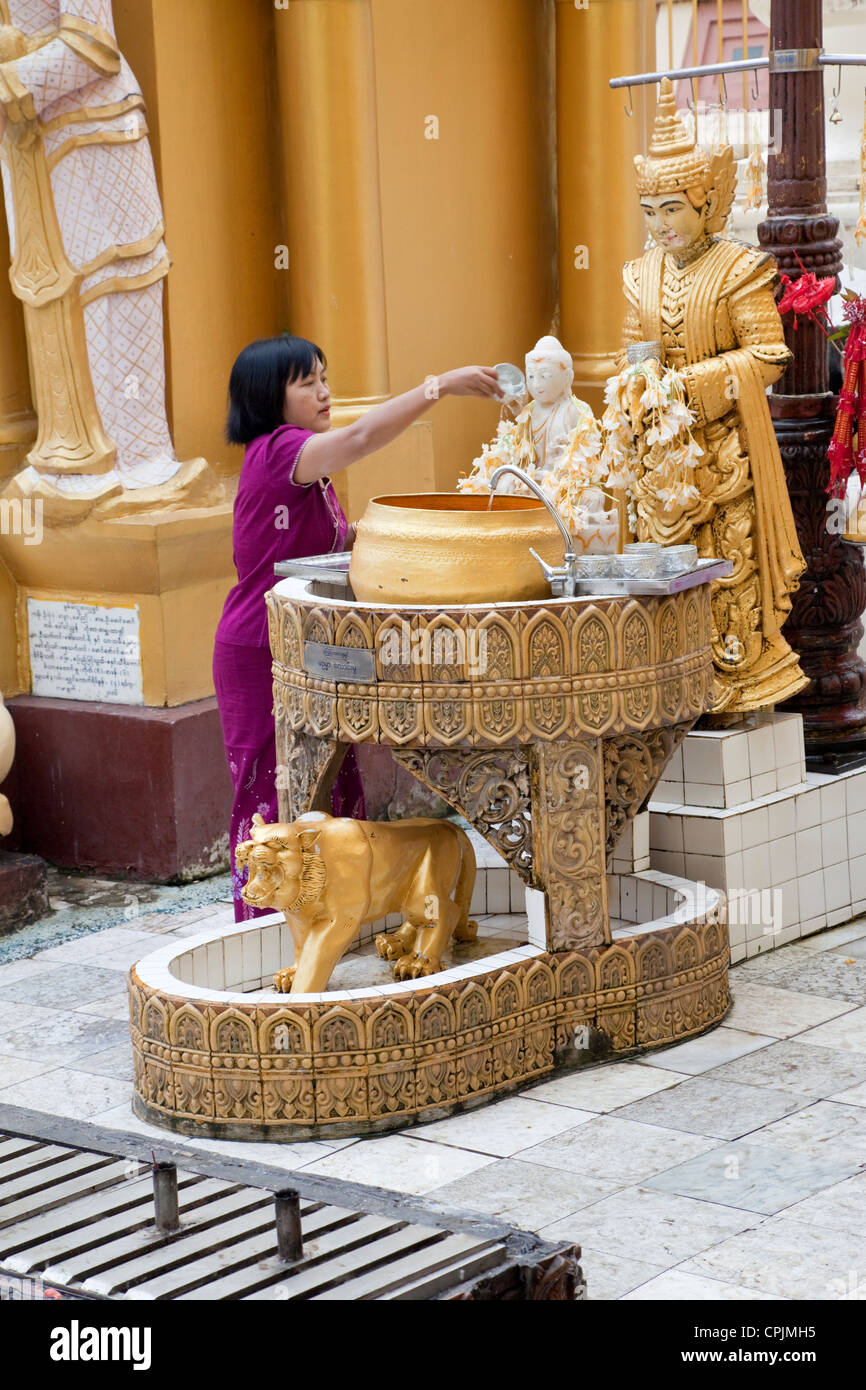 In a Purifying Ritual, Woman Pours Water on a Nat, a Mythical Buddhist ...