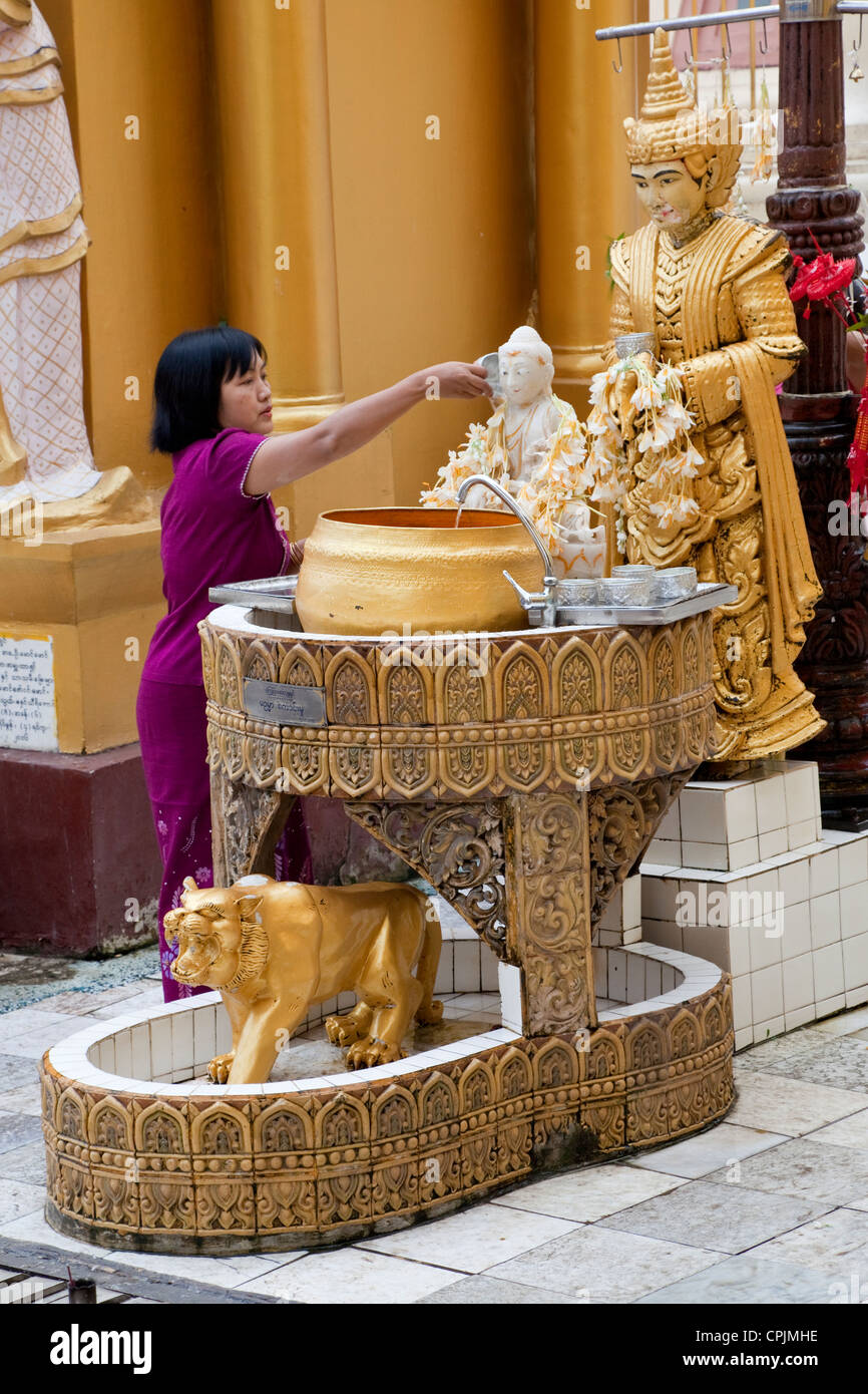 In a Purifying Ritual, Woman Pours Water on a Nat, a Mythical Buddhist ...