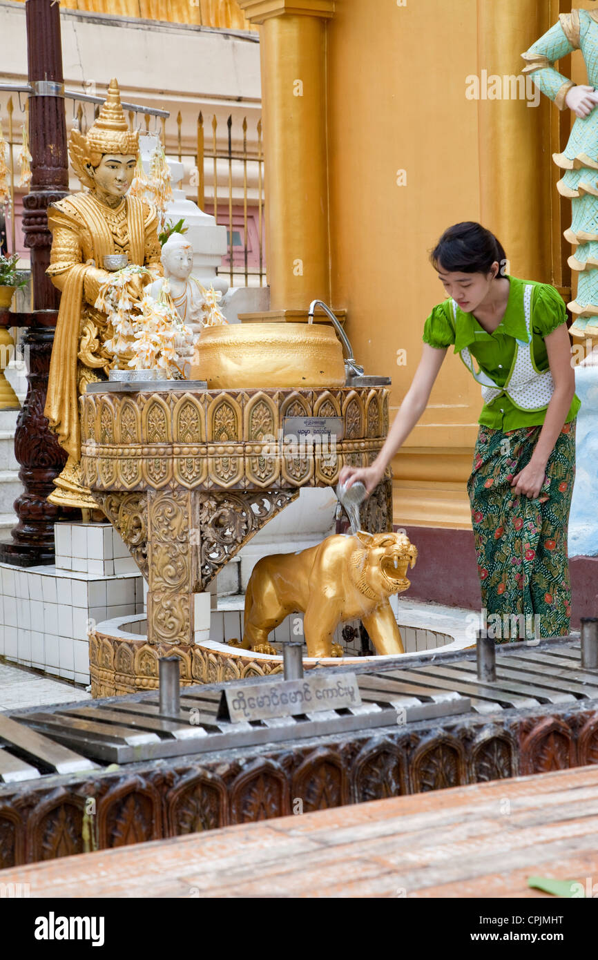 In a Purifying Ritual, Woman Pours Water on a Nat, a Mythical Buddhist ...