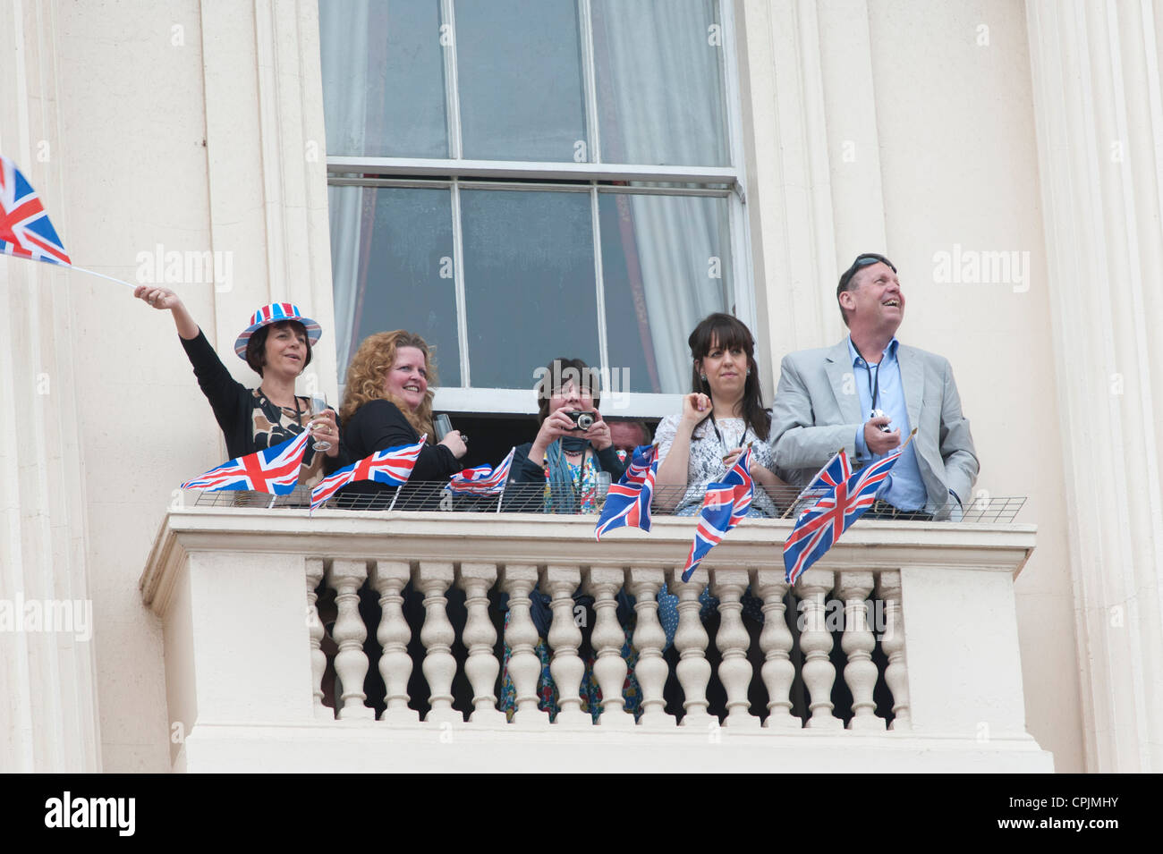 Spectators waving from balcony waiting for the arrival of the wedding ...