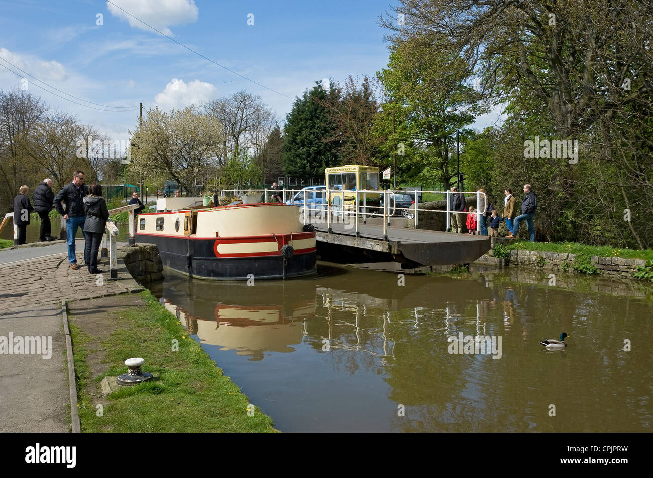 Narrowboat Canal narrow boat passing through swingbridge near Skipton ...