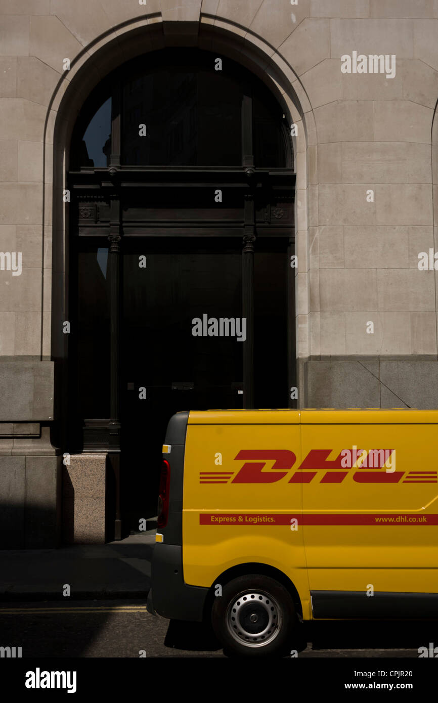 A DHL courier van makes a delivery and is parked in a side street in ...