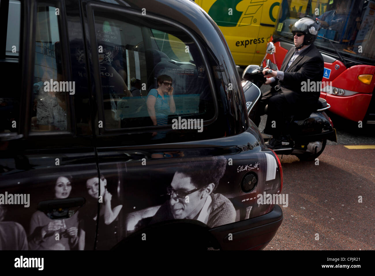 A taxi passenger, commuter traffic and the reflections of a passer-by ...