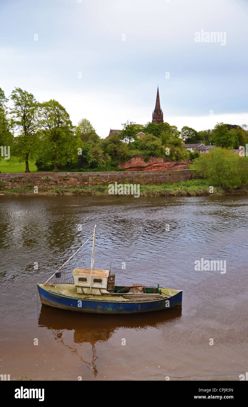 Small run down boat on the river Dee, St Mary without the walls church ...