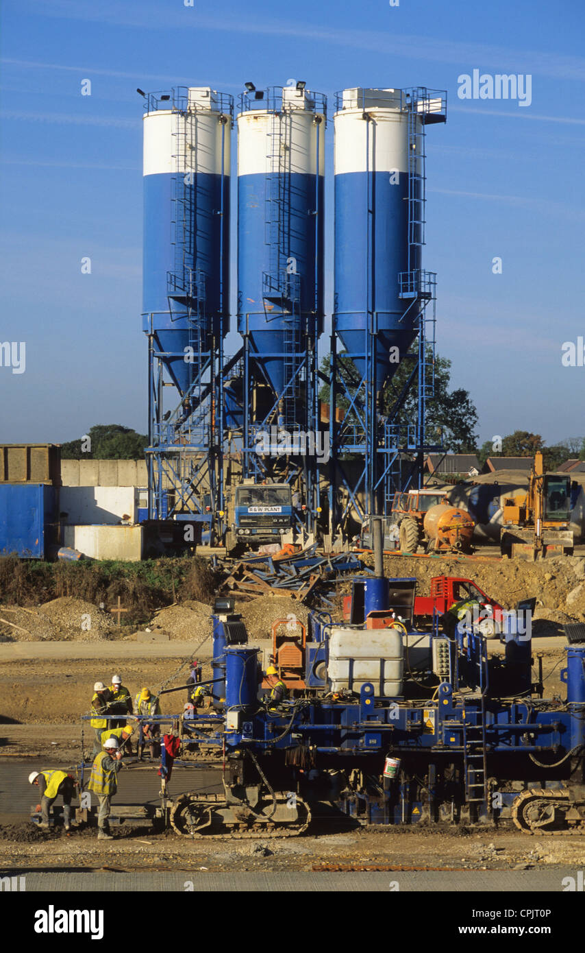 road surface laying machinery and construction workers building a1m ...