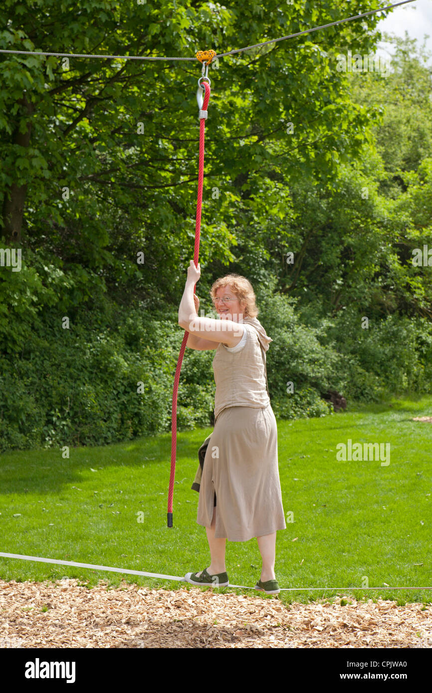 middle-aged woman playing on the playground, Sauerland Park near Hemer ...