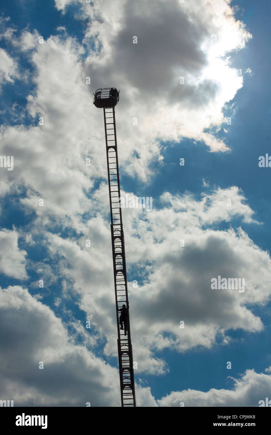 Fireman climbing extended firetruck ladder Stock Photo - Alamy