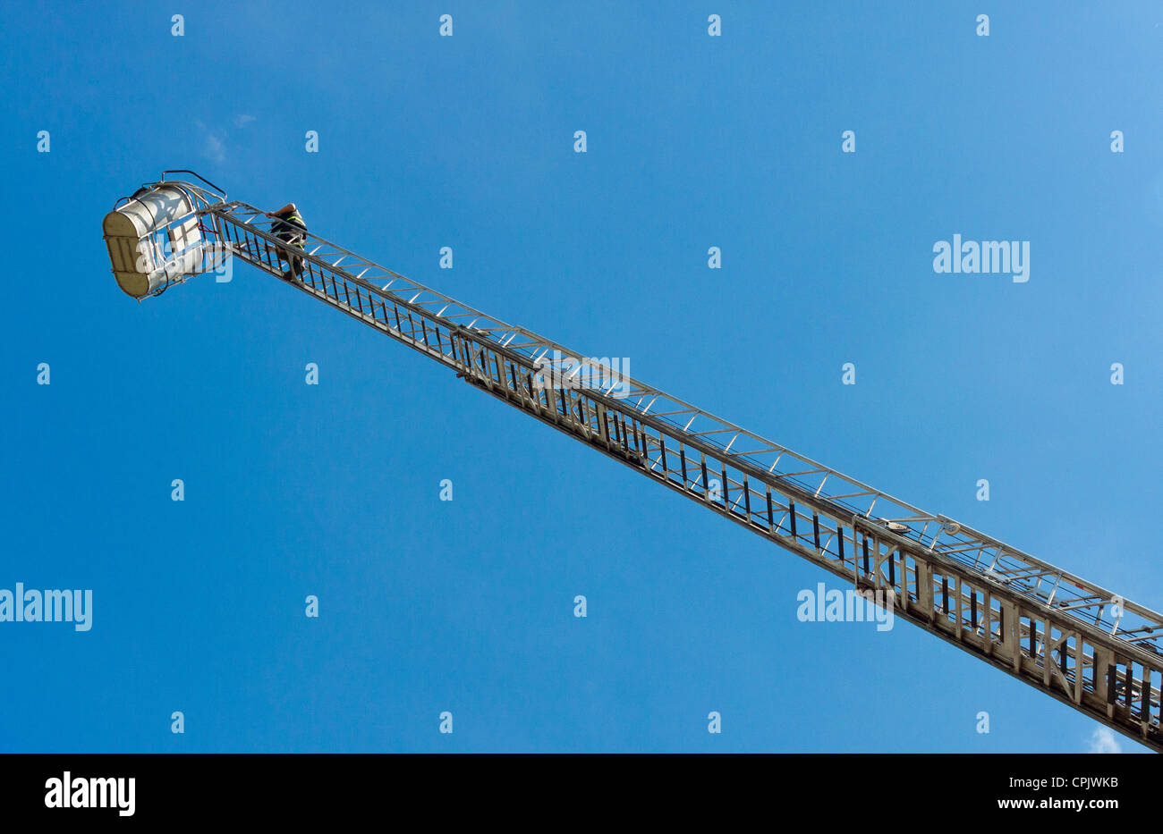 Fireman climbing extended firetruck ladder Stock Photo - Alamy