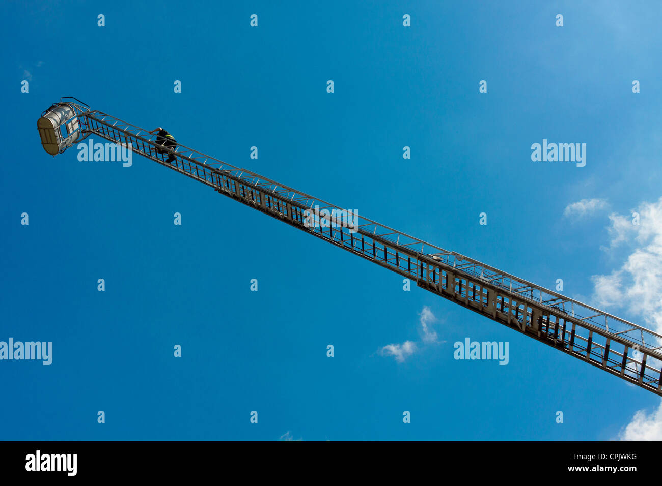 Fireman climbing extended firetruck ladder Stock Photo - Alamy
