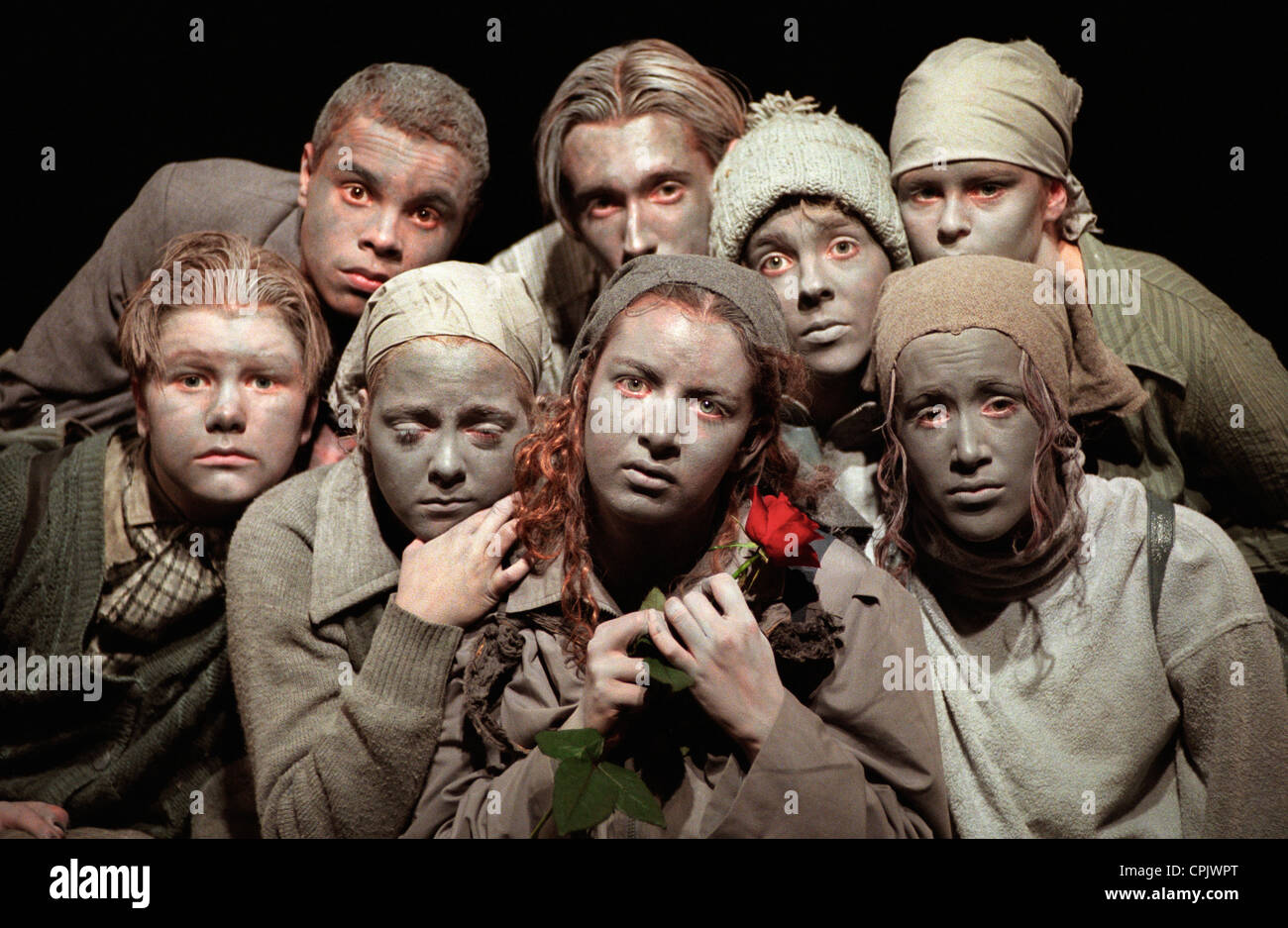 A group of young actors with grey coloured make up perform " Grey ...