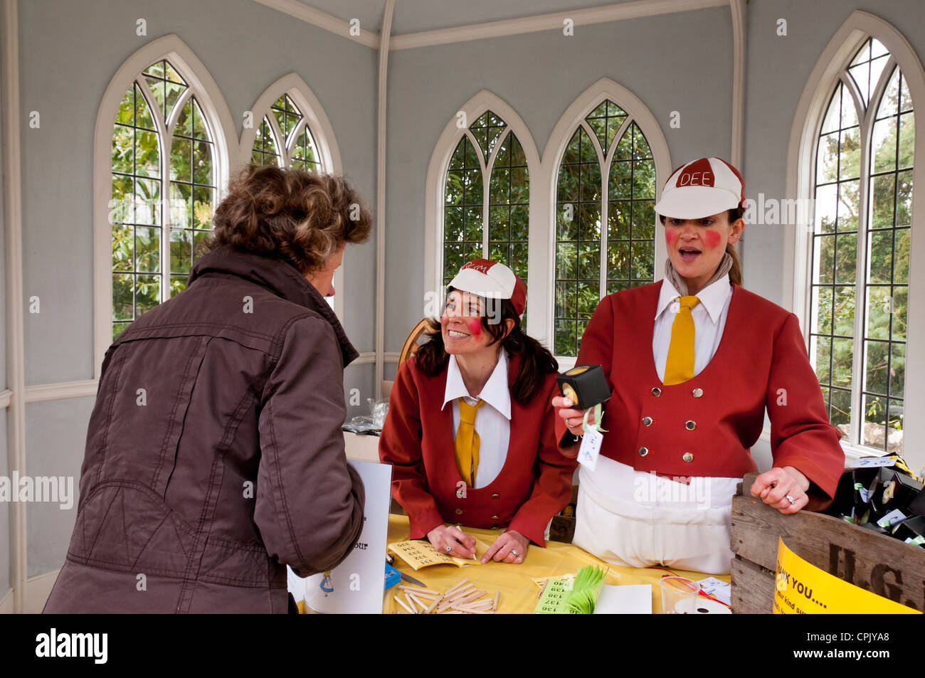 A woman buying raffle tickets from a stall in Rococo Garden, Painswick ...
