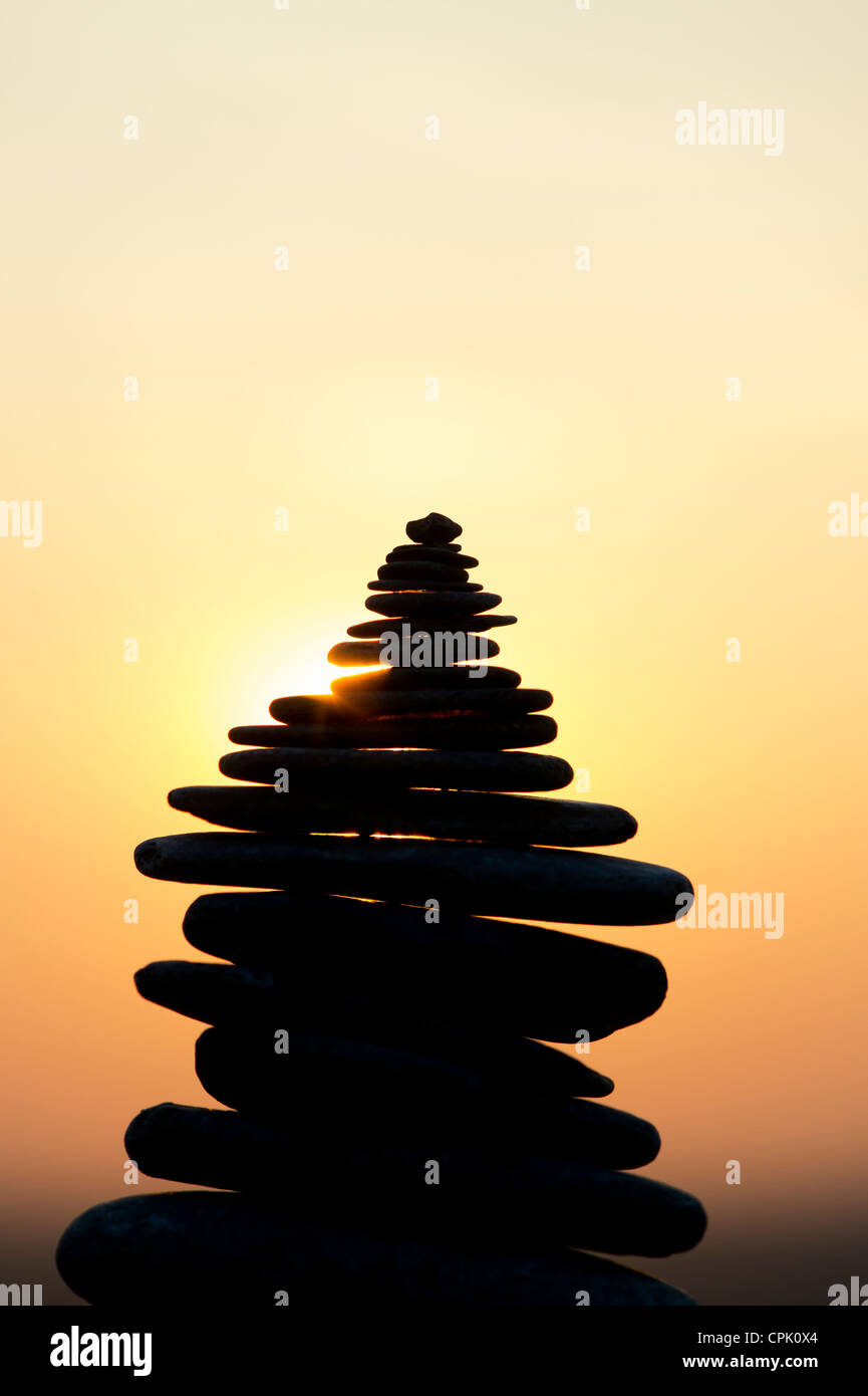 Stacked pebbles silhouette against a sunset. UK Stock Photo - Alamy