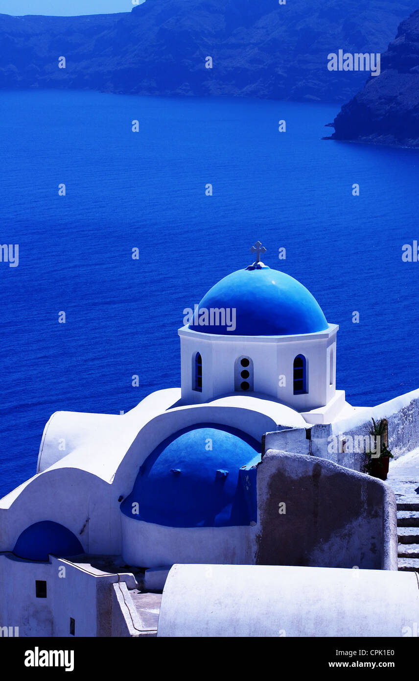 The blue domes of the churches on the Greek island of Santorini make a ...