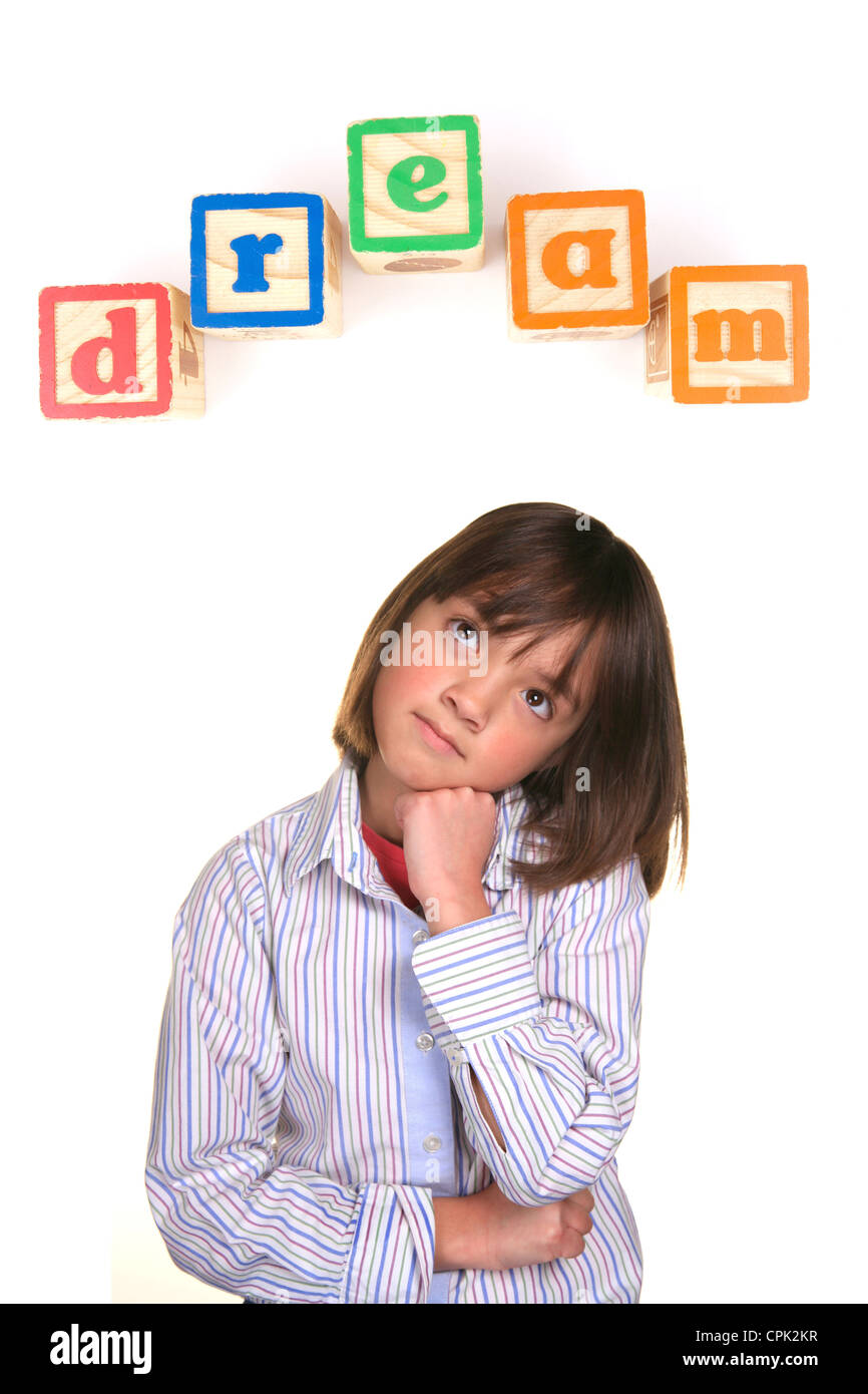A young girl in a dreaming posture with the word dream above in blocks ...