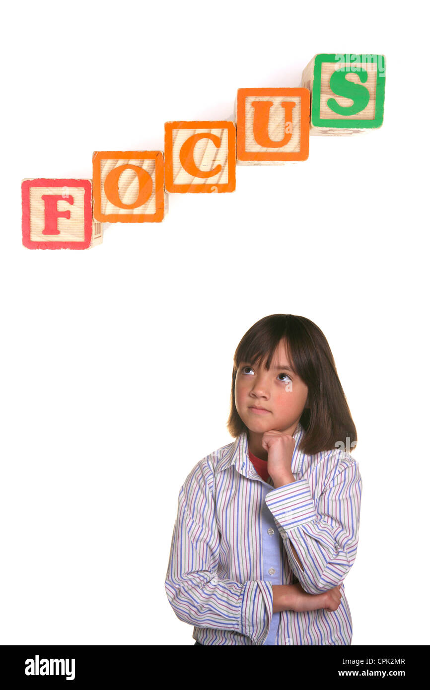 A young student strikes a focused posture with word block above Stock ...