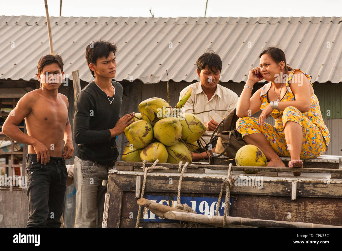 People selling coconuts in the floating market, Cai Rang near Can Tho ...