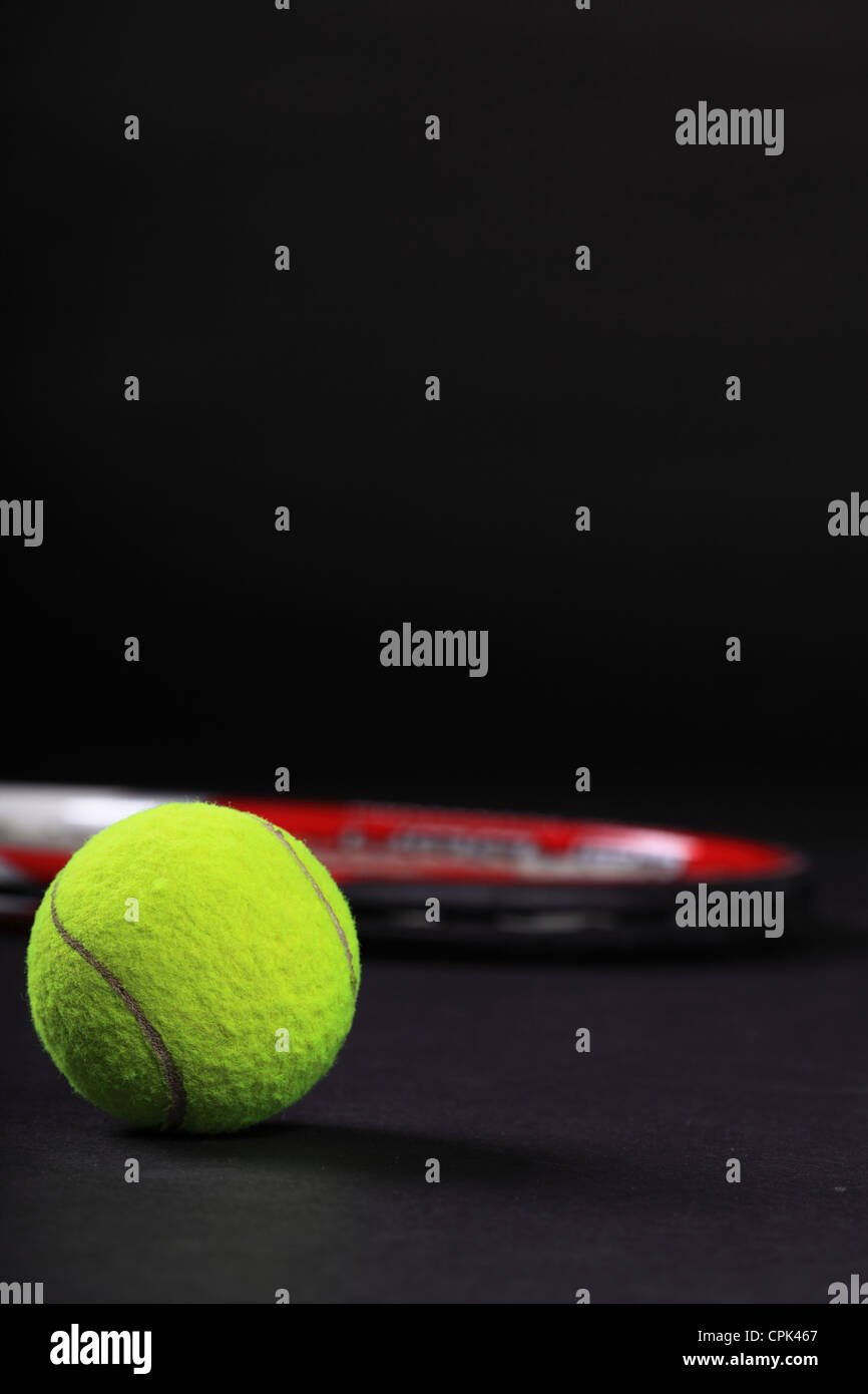 tennis racket and ball on black background studio shot Stock Photo - Alamy