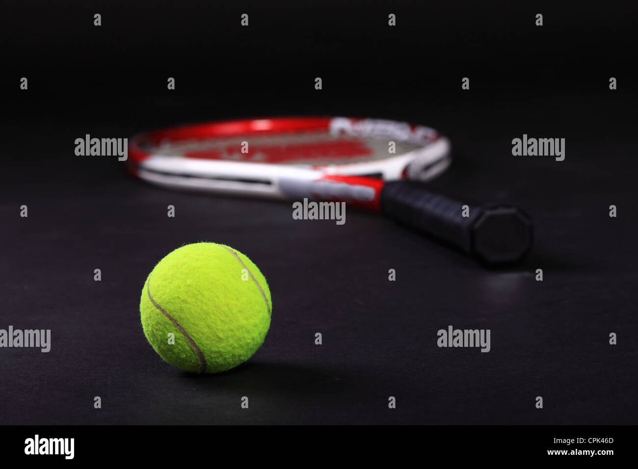 tennis racket and ball on black background studio shot Stock Photo - Alamy