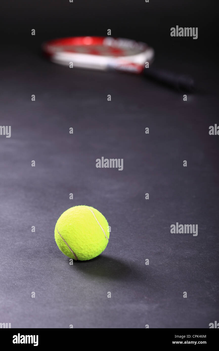 tennis racket and ball on black background studio shot Stock Photo - Alamy
