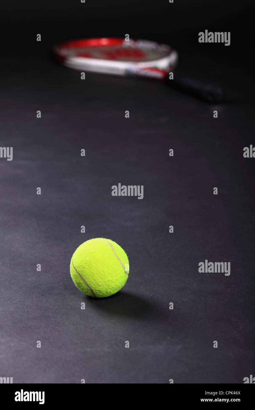 tennis racket and ball on black background studio shot Stock Photo - Alamy