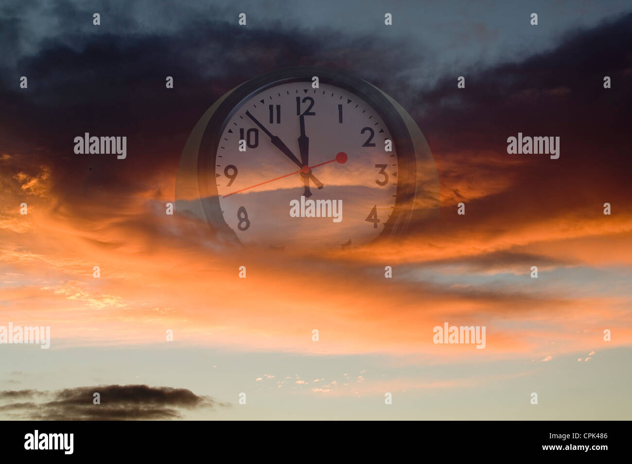 Clock floating in the sky among clouds at sunset Stock Photo - Alamy