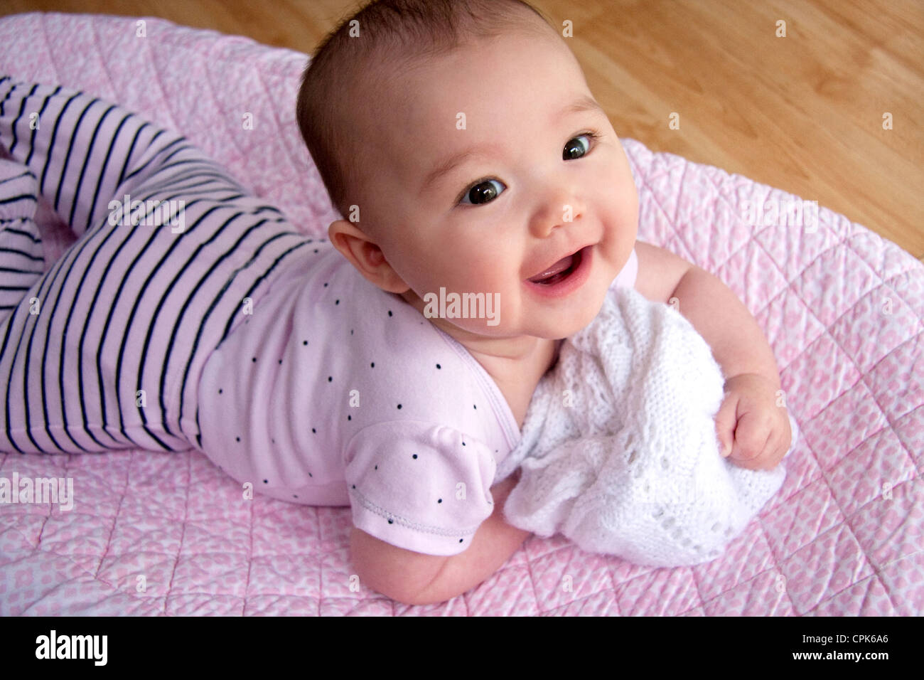 Laughing baby on her tummy Stock Photo - Alamy