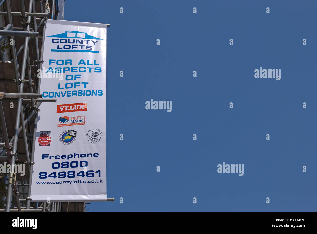 banner hanging from scaffolding advertising a loft conversion company ...