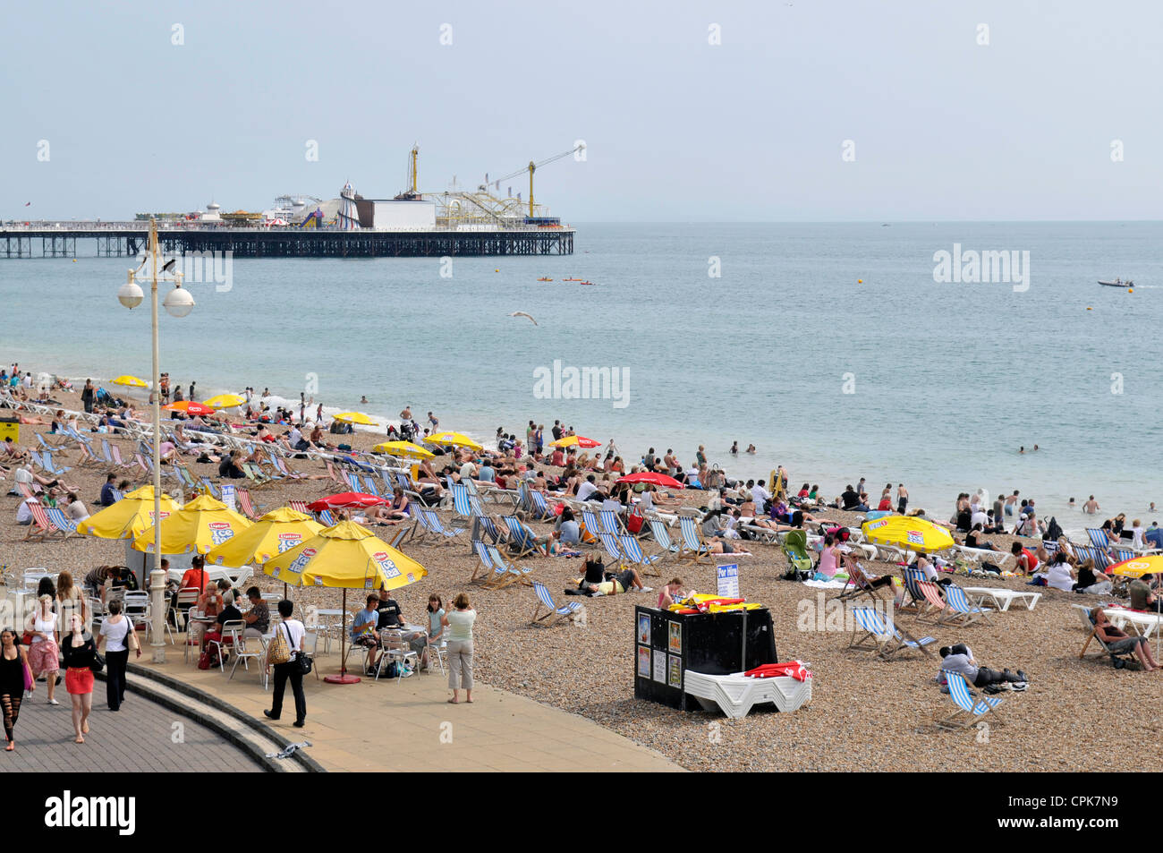Brighton seafront on a summer's afternoon featuring the pier and people ...