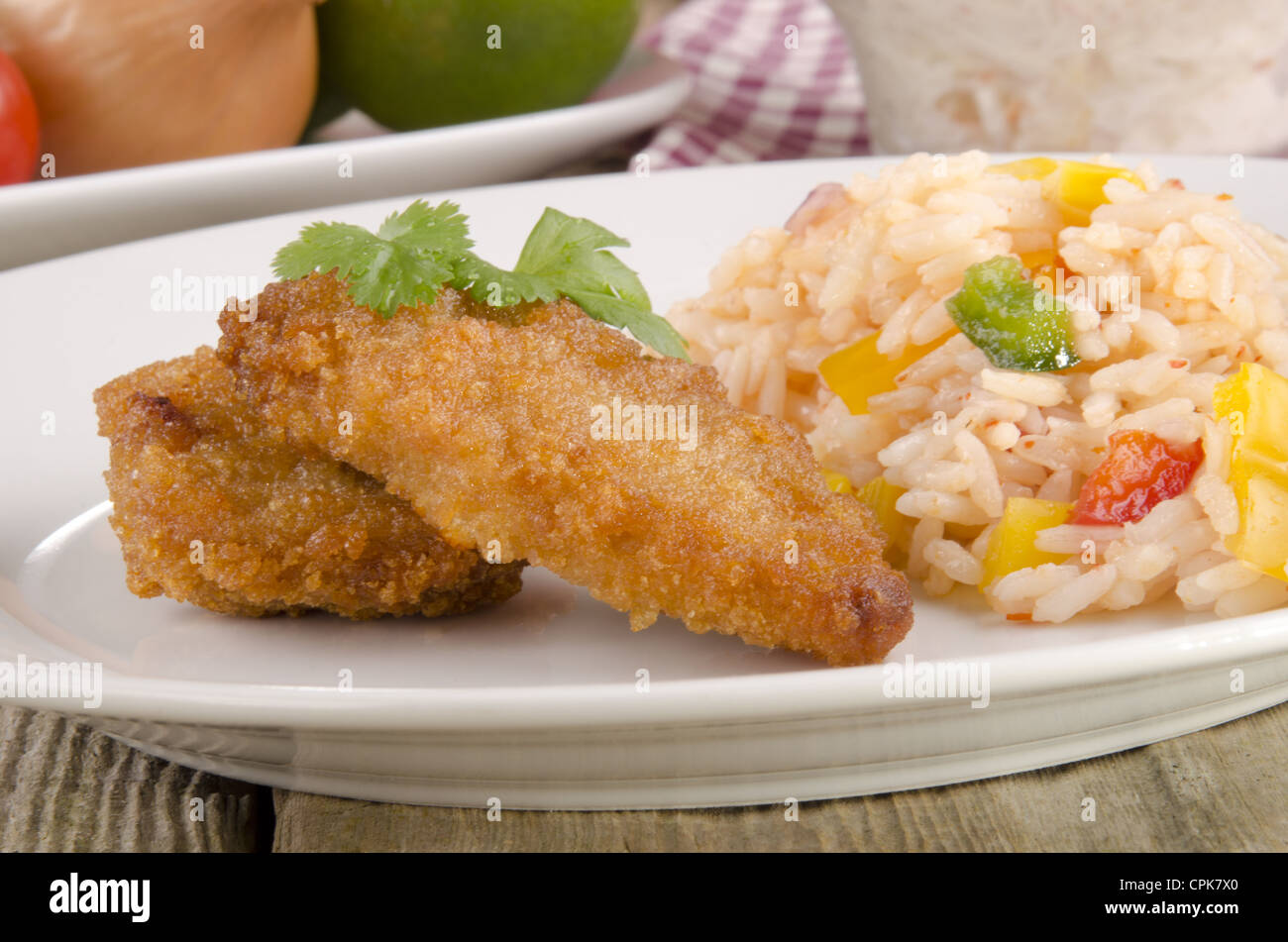 breaded chicken nuggets with rice salad on a plate Stock Photo - Alamy