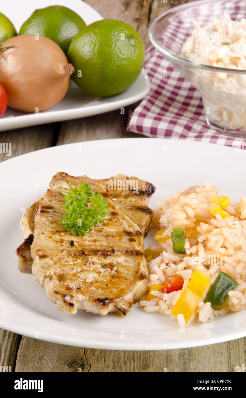 grilled pork chops with rice salad on a plate Stock Photo - Alamy