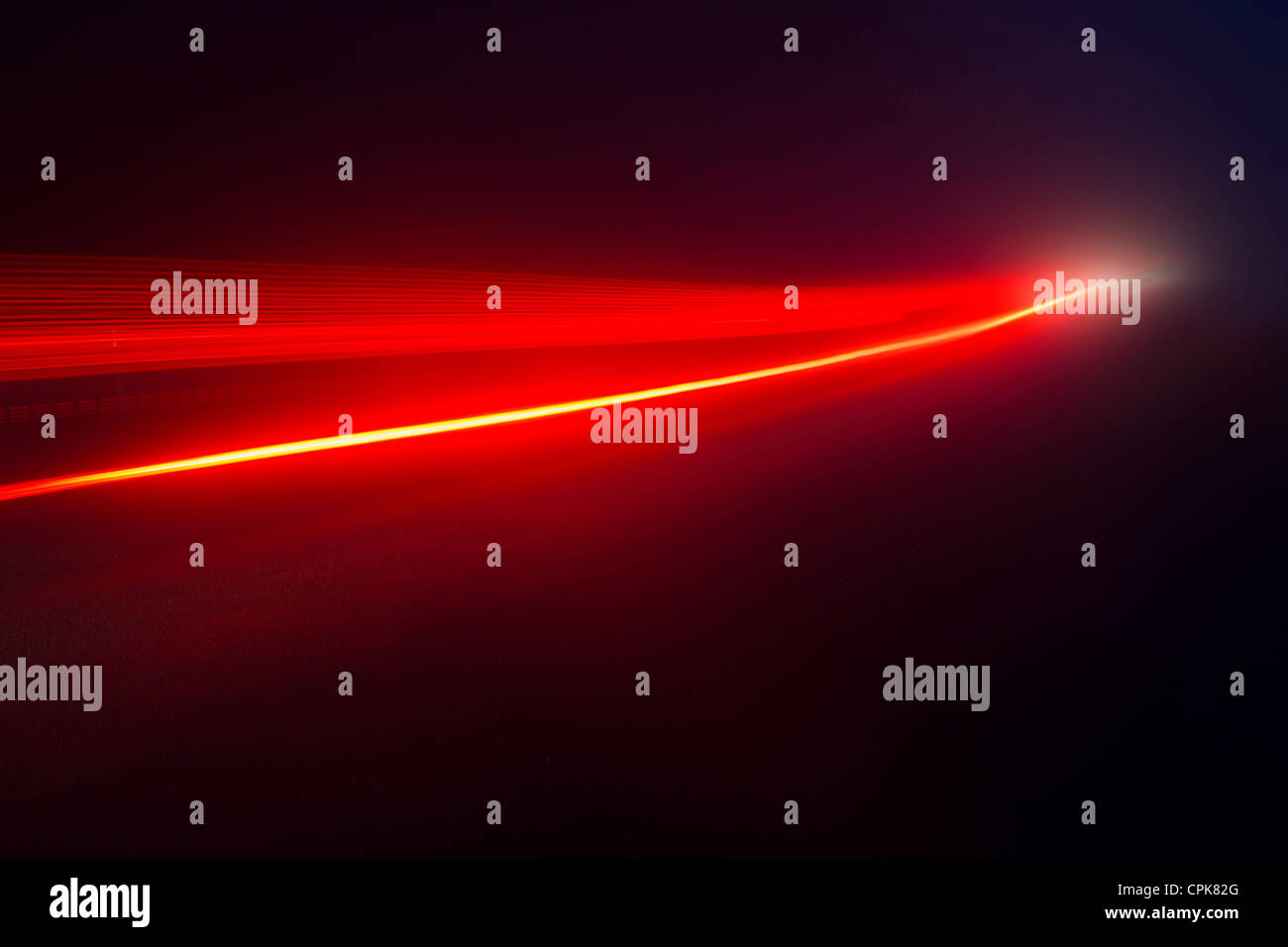 Processed photograph of a red streak of light Stock Photo - Alamy