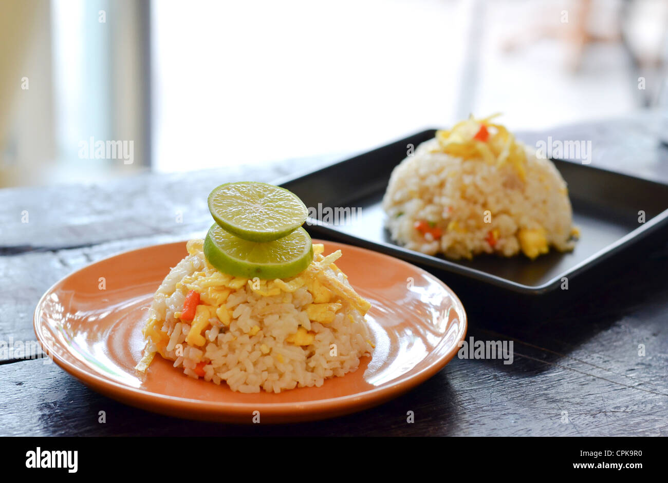two dish of fried rice on wood table Stock Photo - Alamy